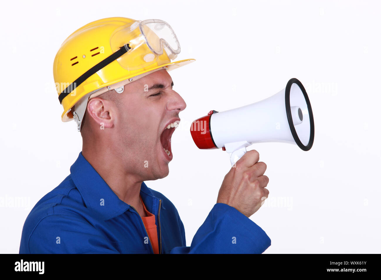 Construction worker shouting into megaphone Stock Photo - Alamy