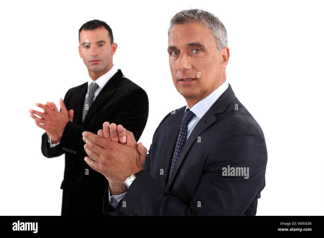 Businessmen rubbing their hands Stock Photo - Alamy