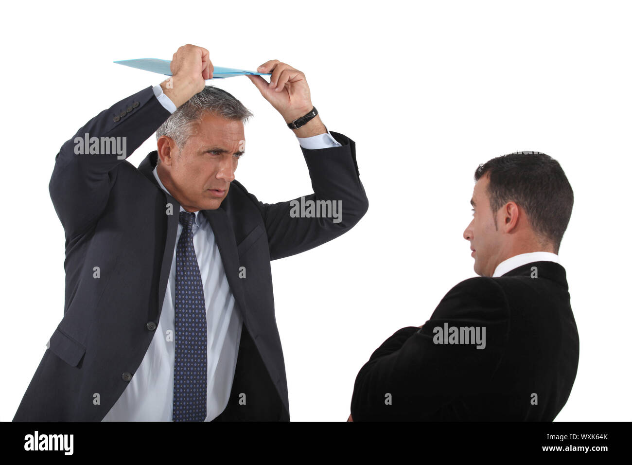Angry boss about to hit employee with clip-board Stock Photo - Alamy