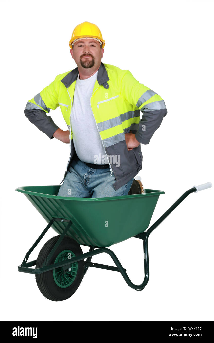 Mason kneeling in wheelbarrow Stock Photo - Alamy