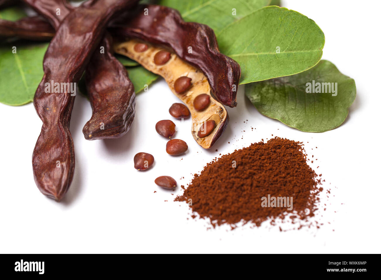 Carob beans. Healthy organic sweet carob pods with seeds and leaves on ...