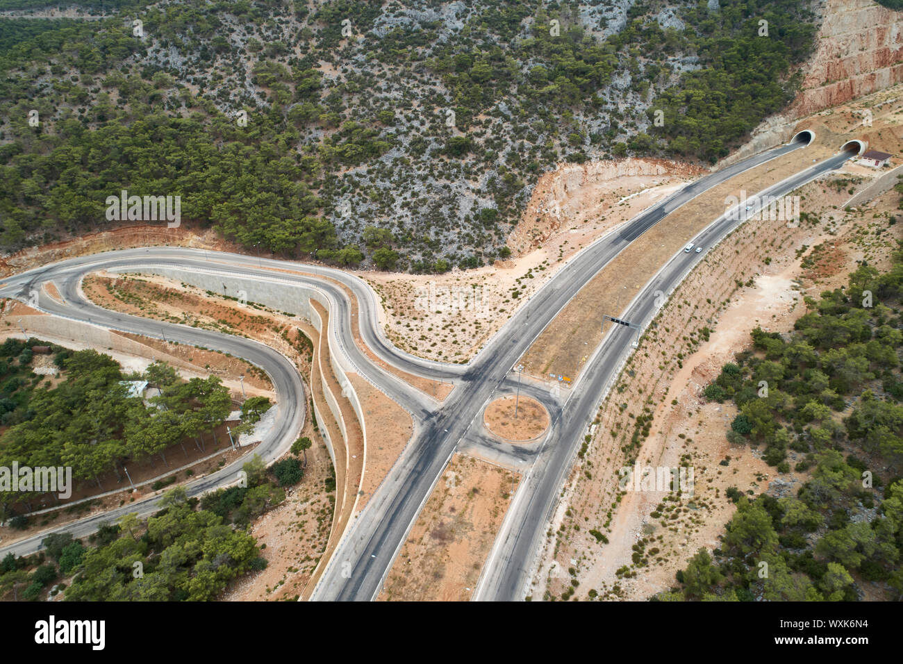 Highway interchange with roundabout, hairpin bends, retaining walls and ...