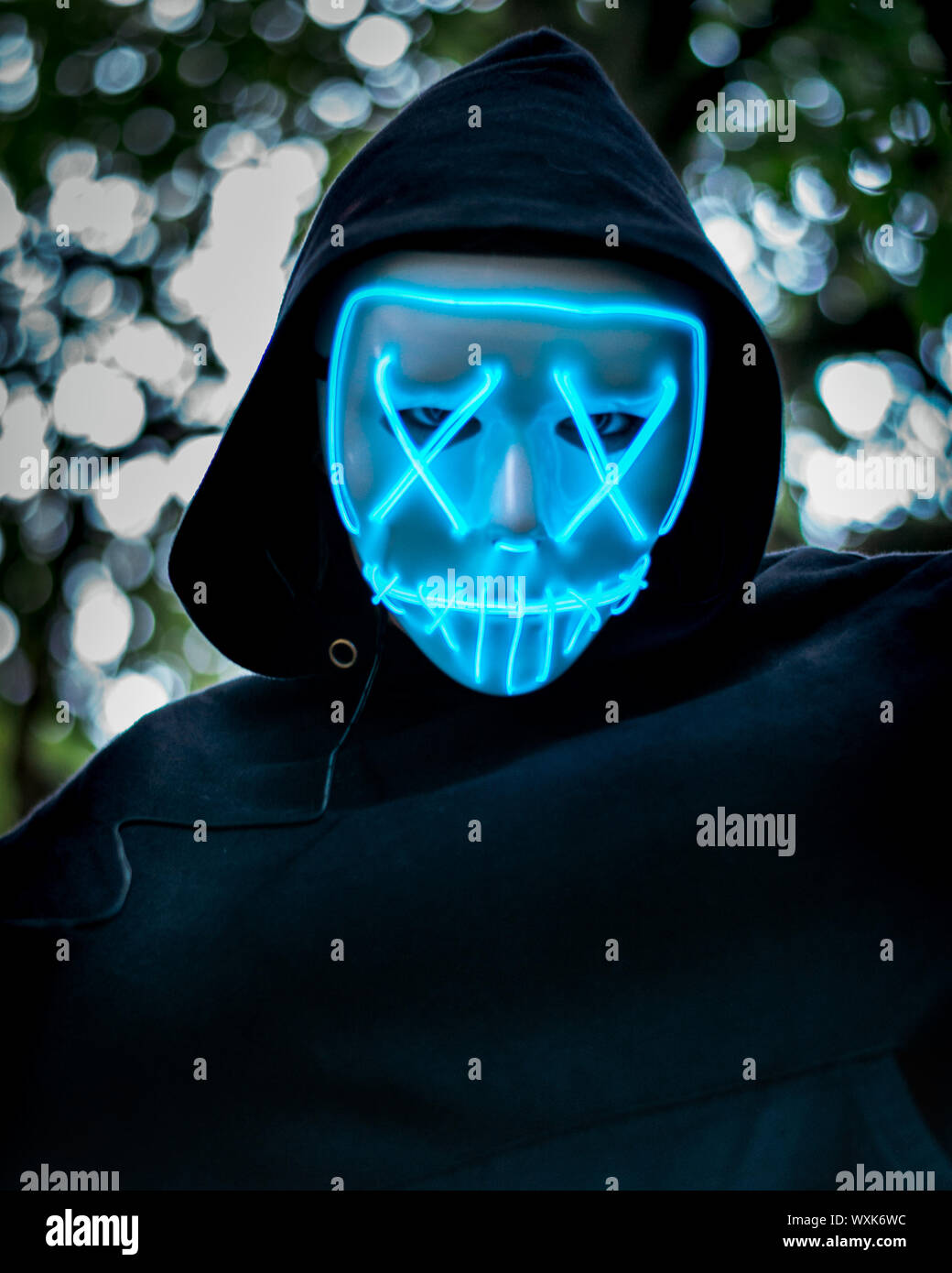 Isolated person wearing creepy light up halloween mask Stock Photo - Alamy