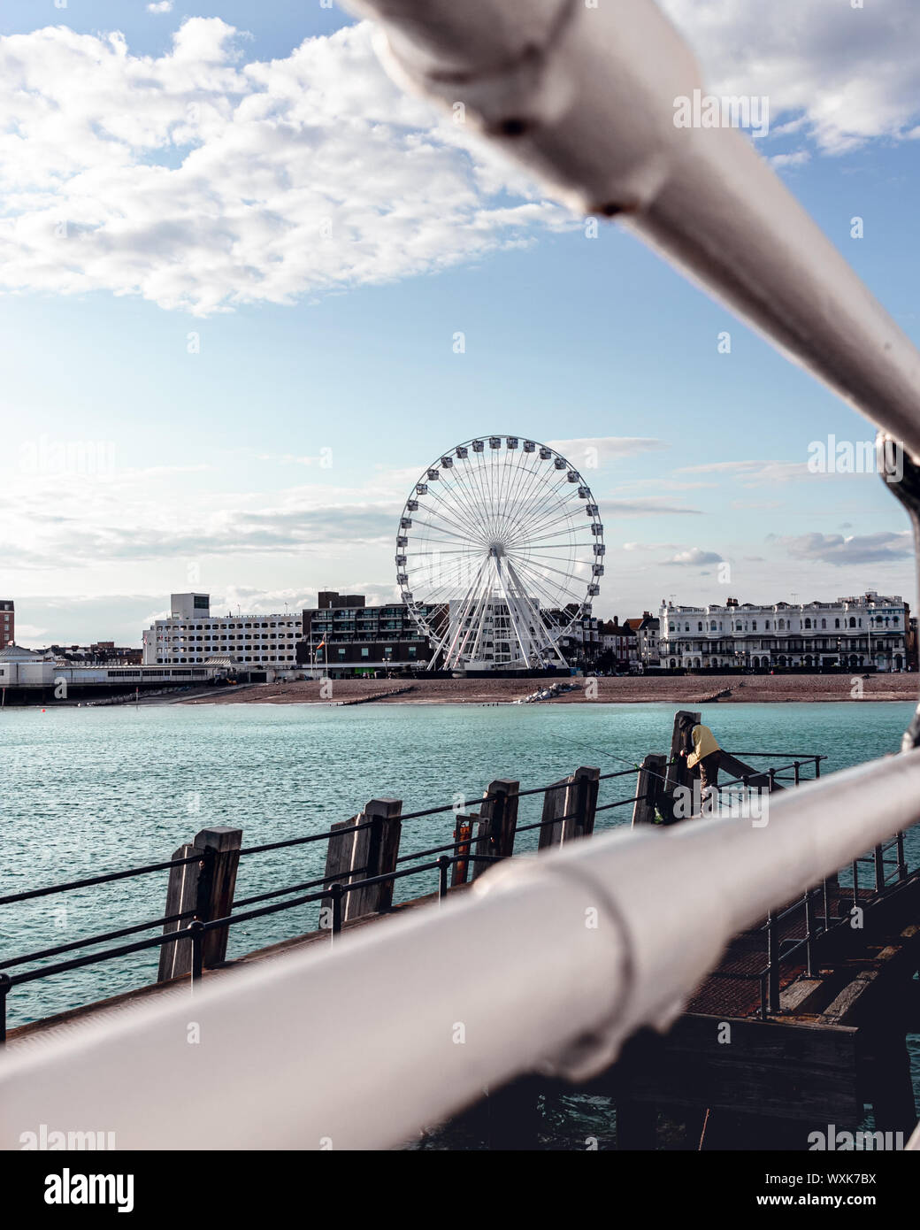 Isolated Ferris wheel with still blue waters and bright sky Stock Photo ...