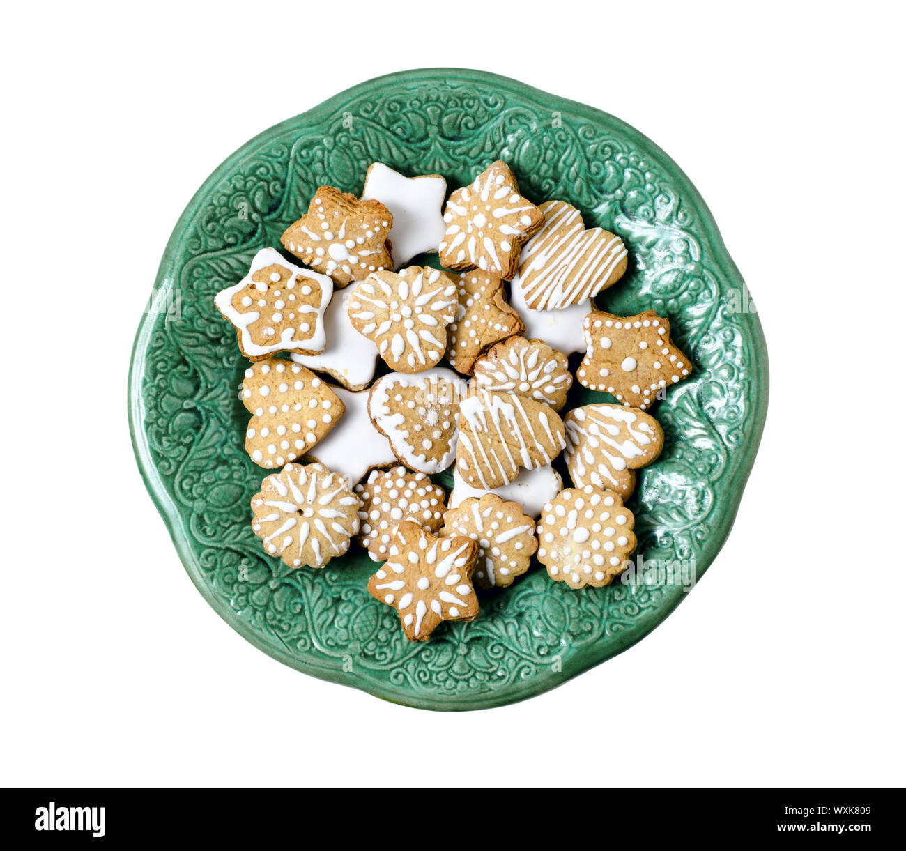 Homemade gingerbread cookies on a green vintage plate isolated on a ...