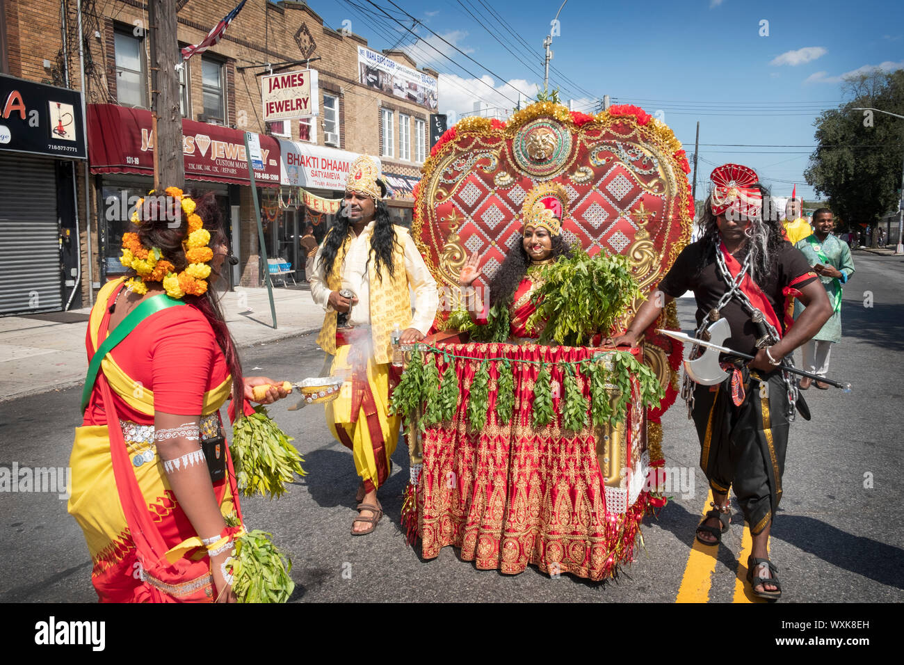 A woman performs the arti ritual in front of a woman dressed as ...