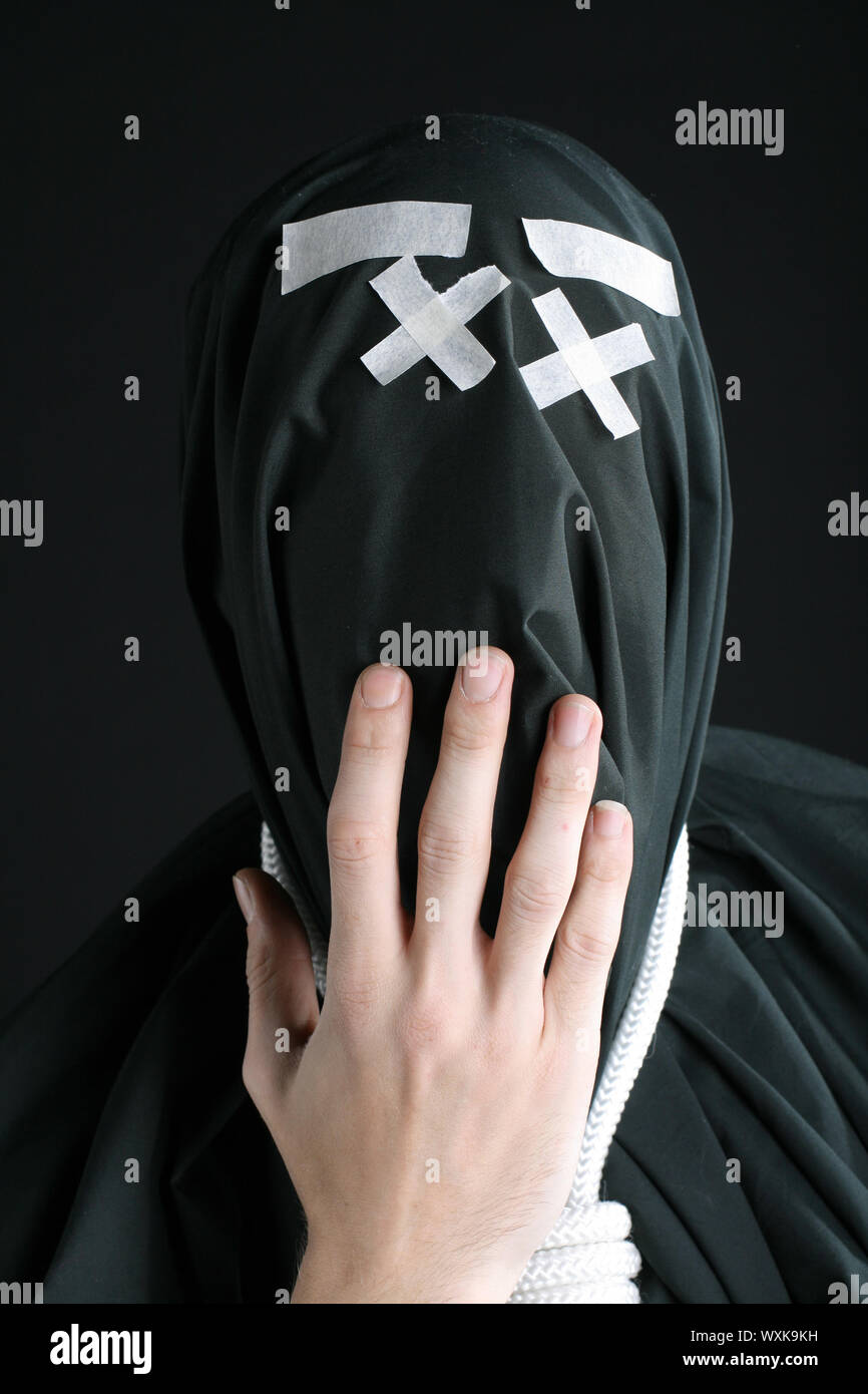Black mime with rope on neck on black background Stock Photo - Alamy