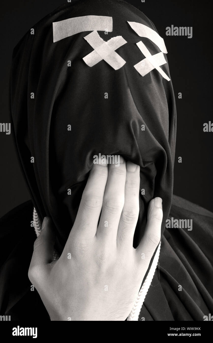 Black mime with rope on neck on black background Stock Photo - Alamy