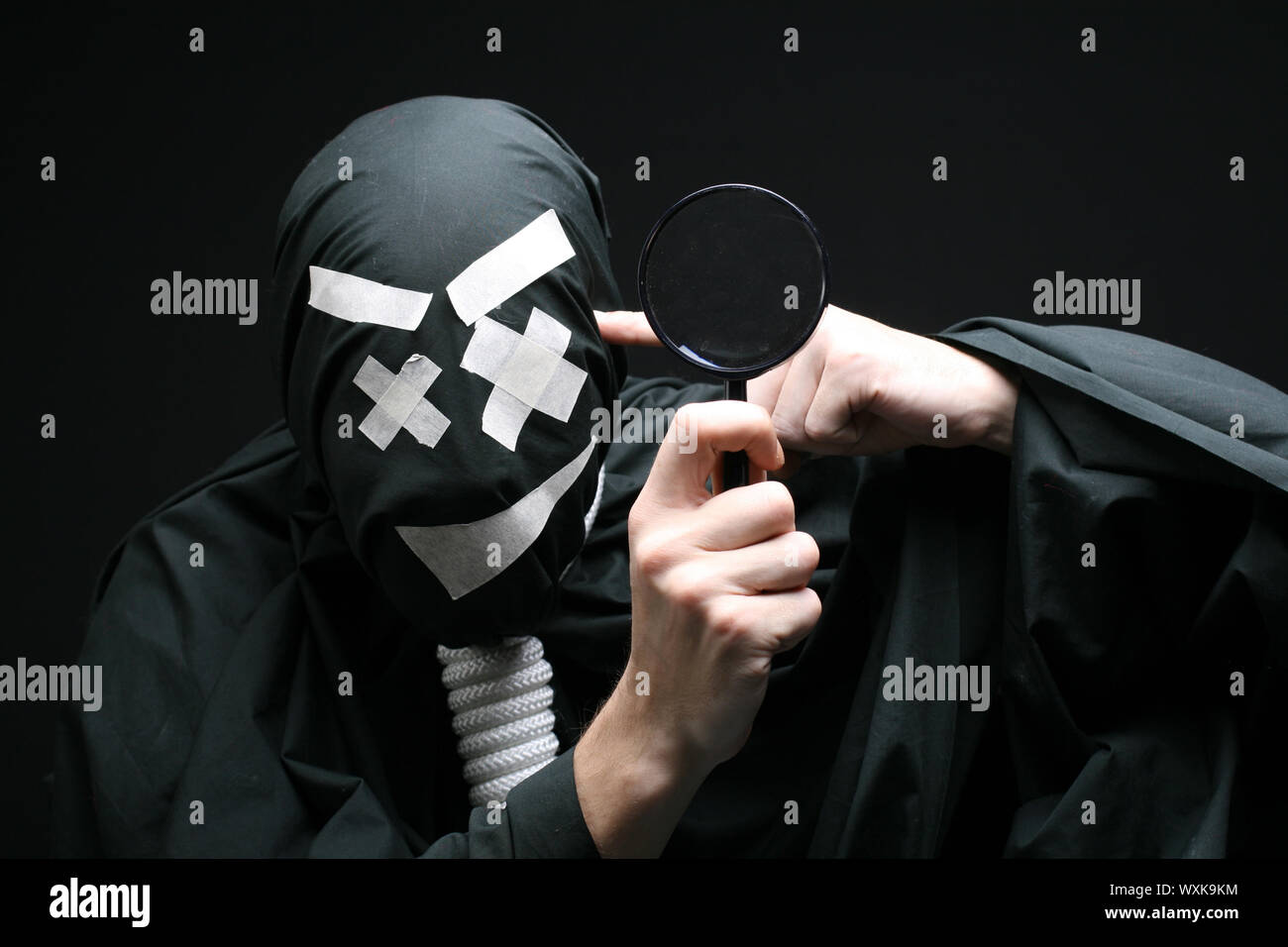 Black mime with rope on neck on black background Stock Photo - Alamy