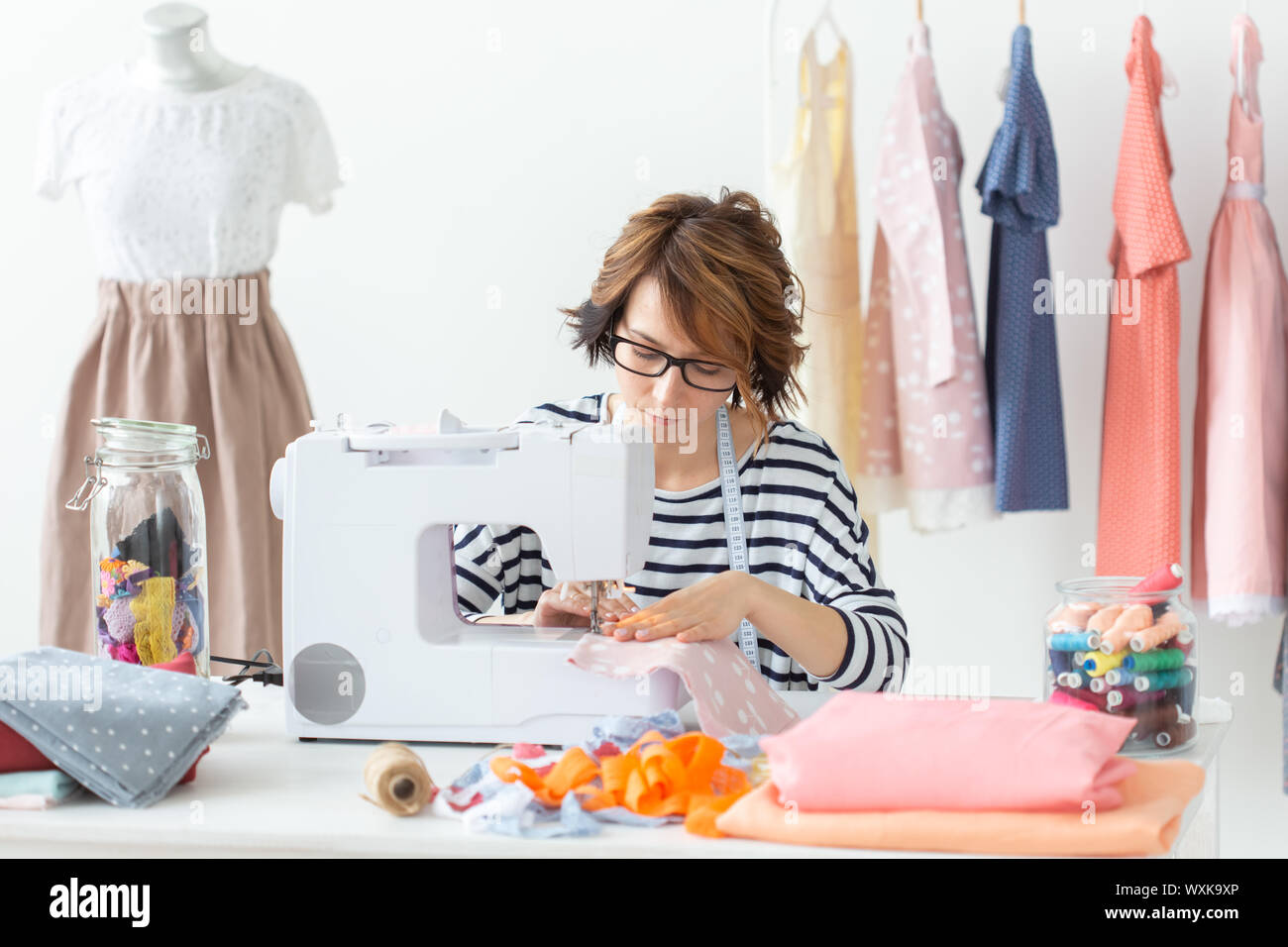 clothing designer, seamstress, people concept - clothing designer ...