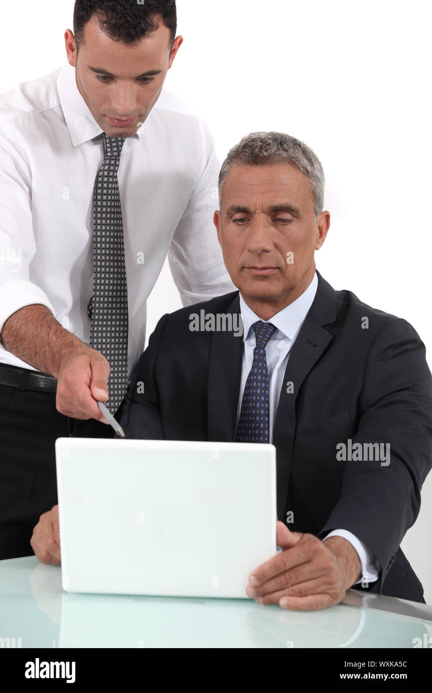 Executives looking computer project Stock Photo - Alamy