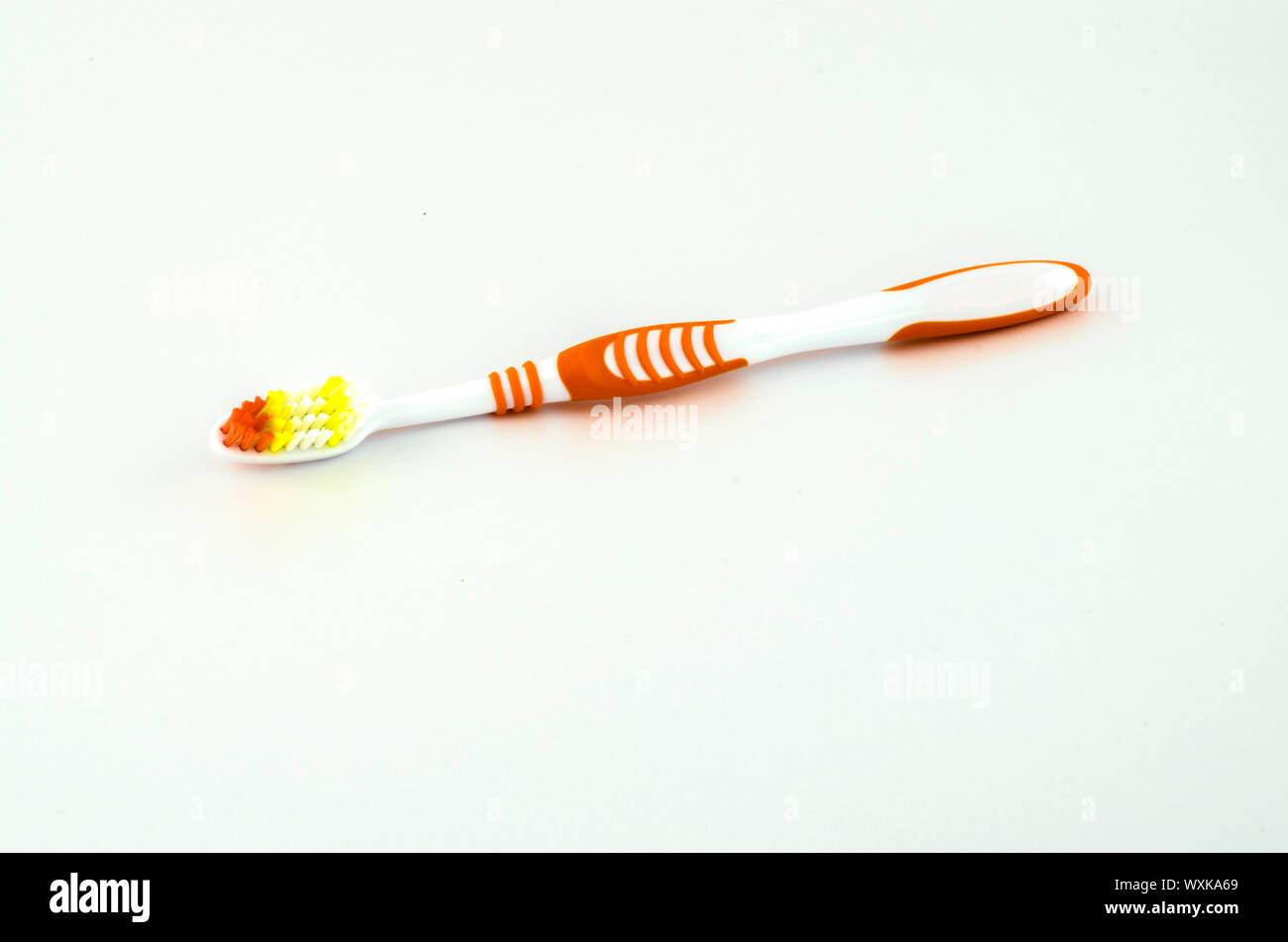 orange tooth brush isolated on white background Stock Photo - Alamy