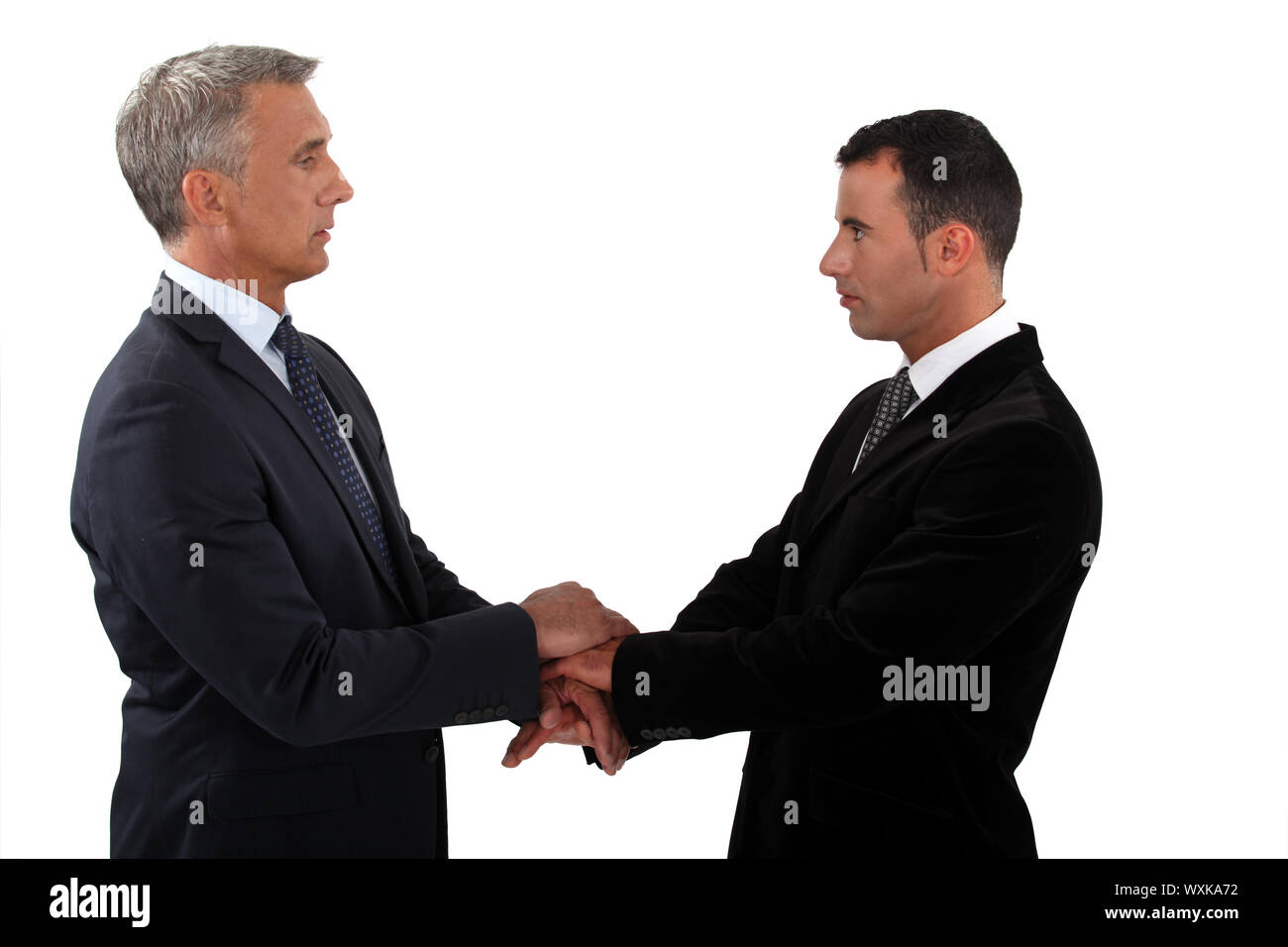 Businessmen shaking hands Stock Photo - Alamy