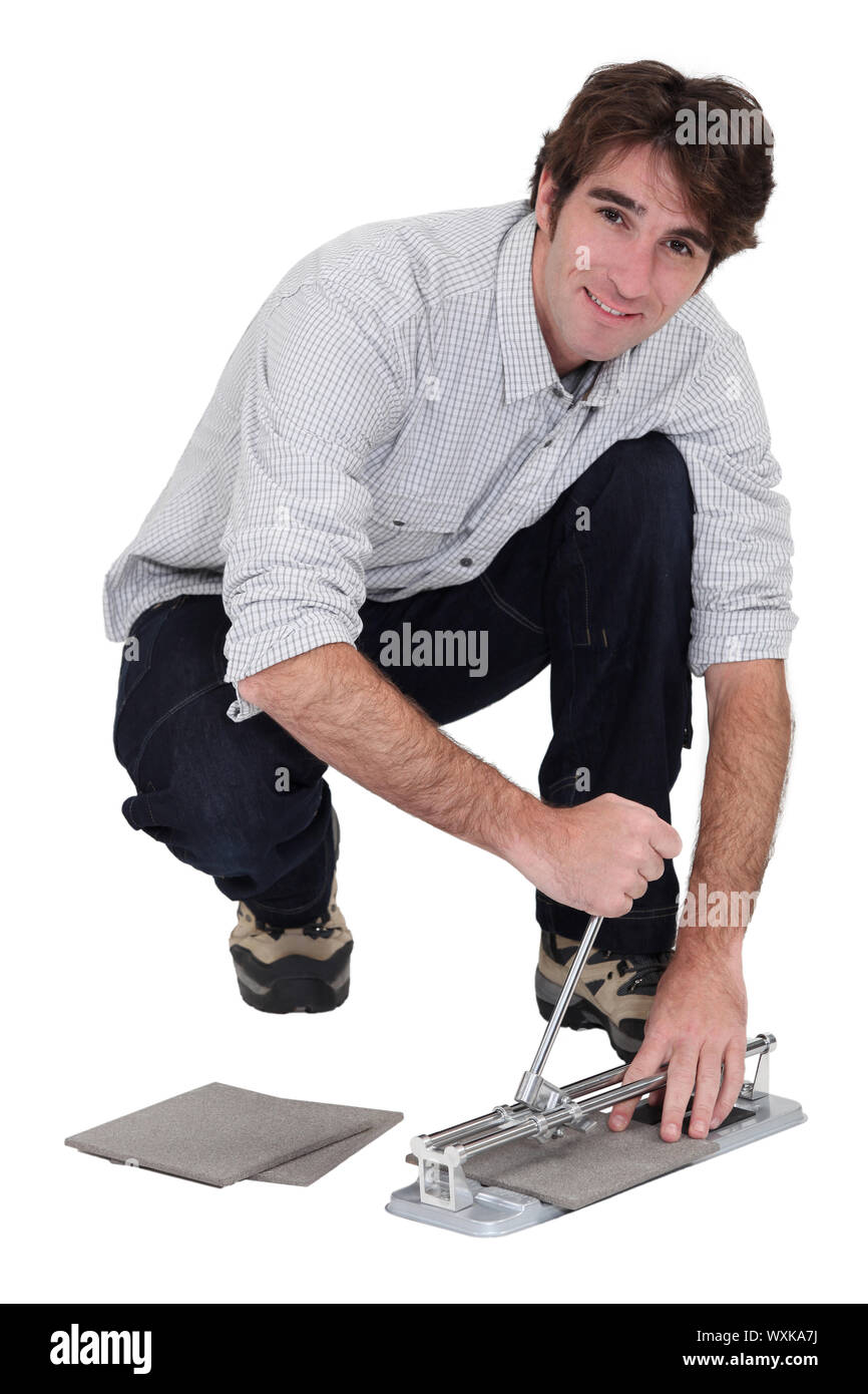 Man cutting tile Stock Photo - Alamy