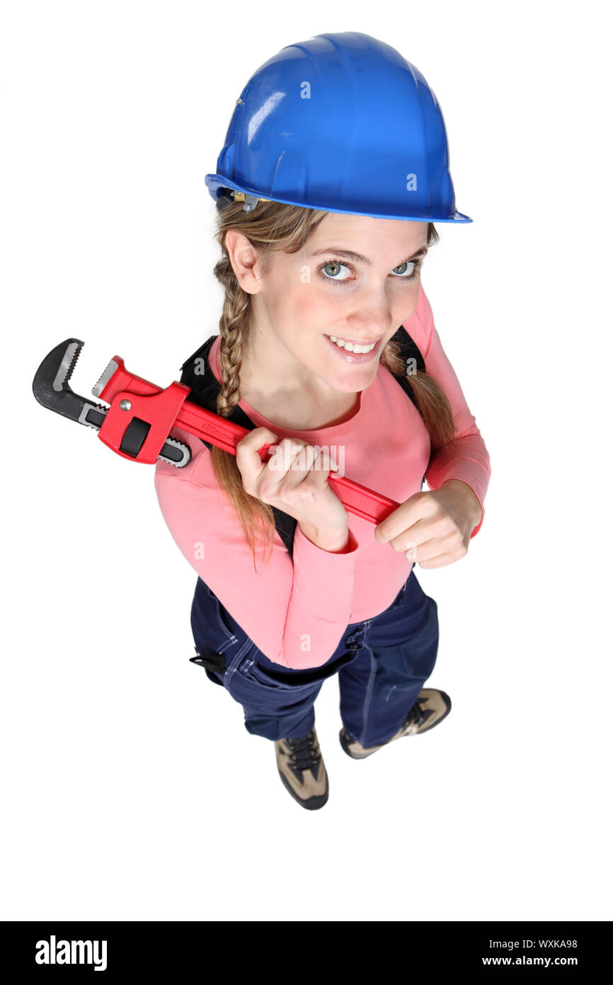 Female worker holding wrench Stock Photo - Alamy