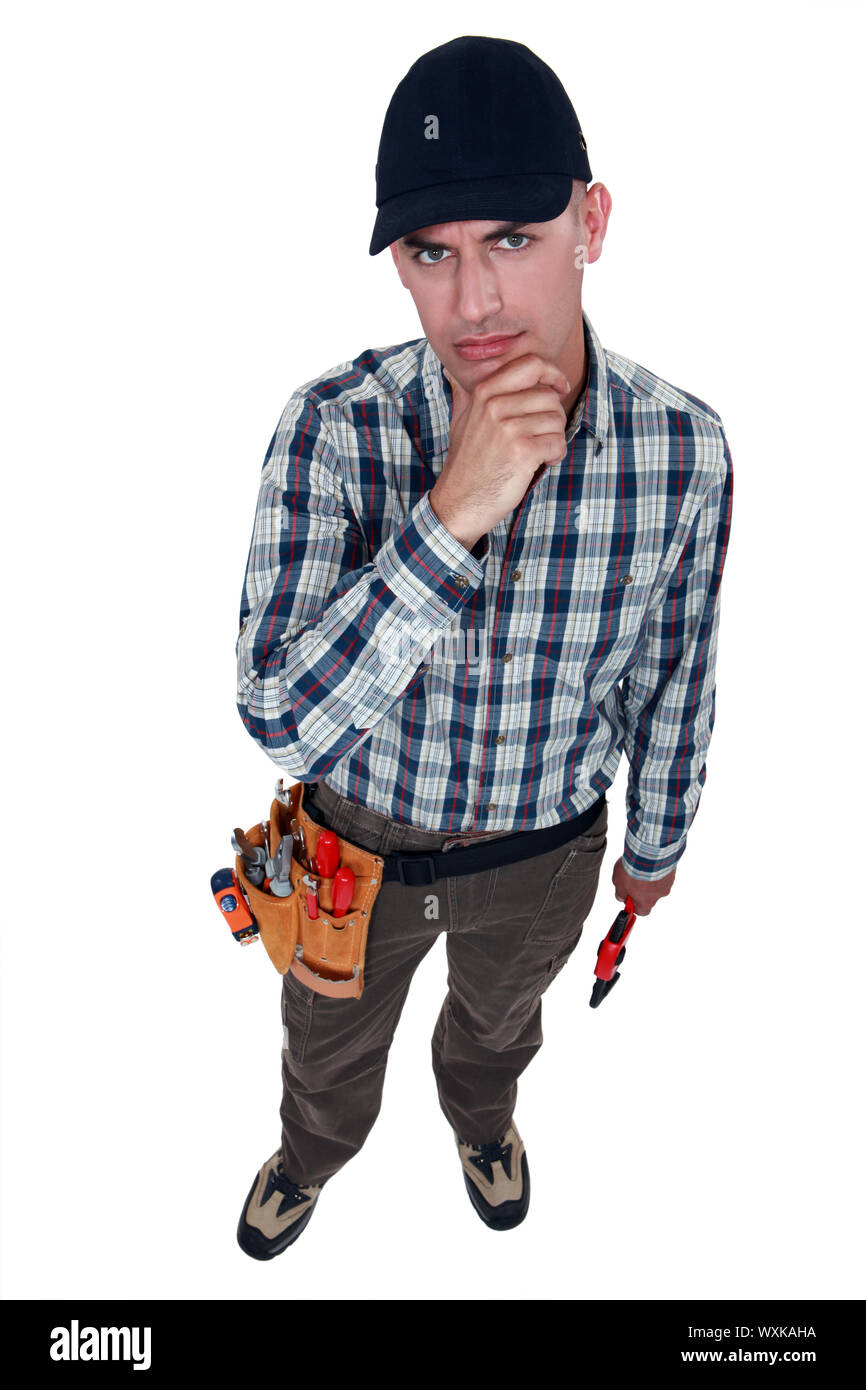A perplexed handyman Stock Photo - Alamy
