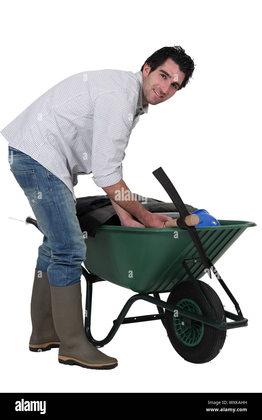 Man with a wheelbarrow Stock Photo - Alamy