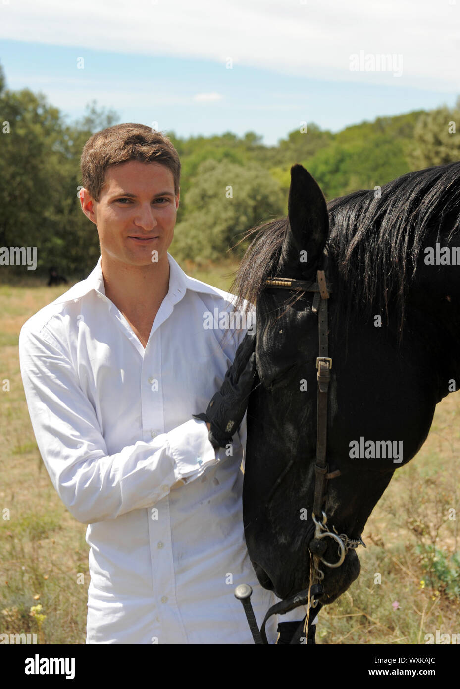 Young man beautiful black stallion hi-res stock photography and images ...