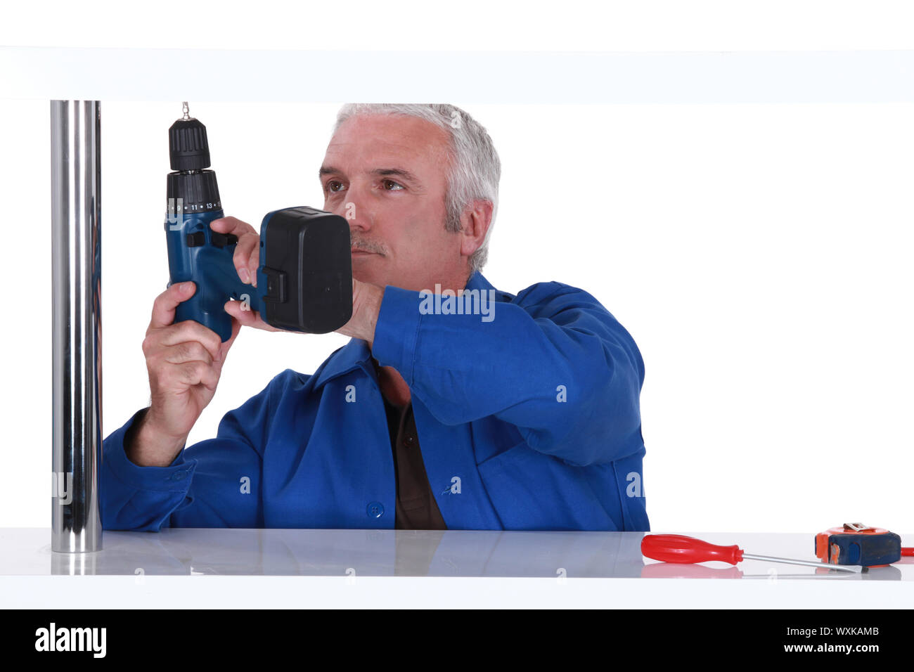Man putting up a shelf Stock Photo - Alamy