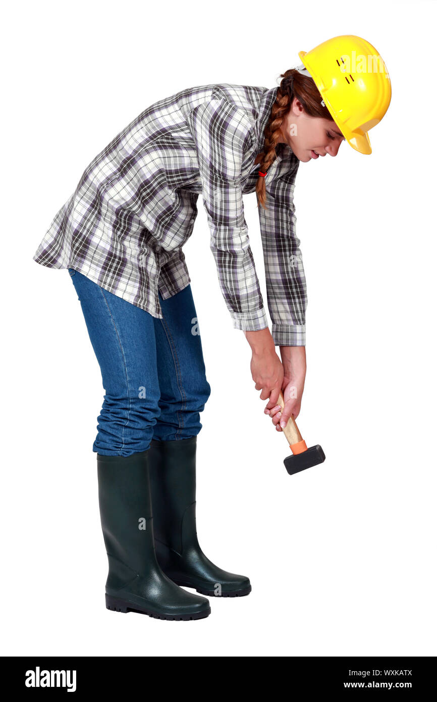 Female construction worker with hammer Stock Photo - Alamy