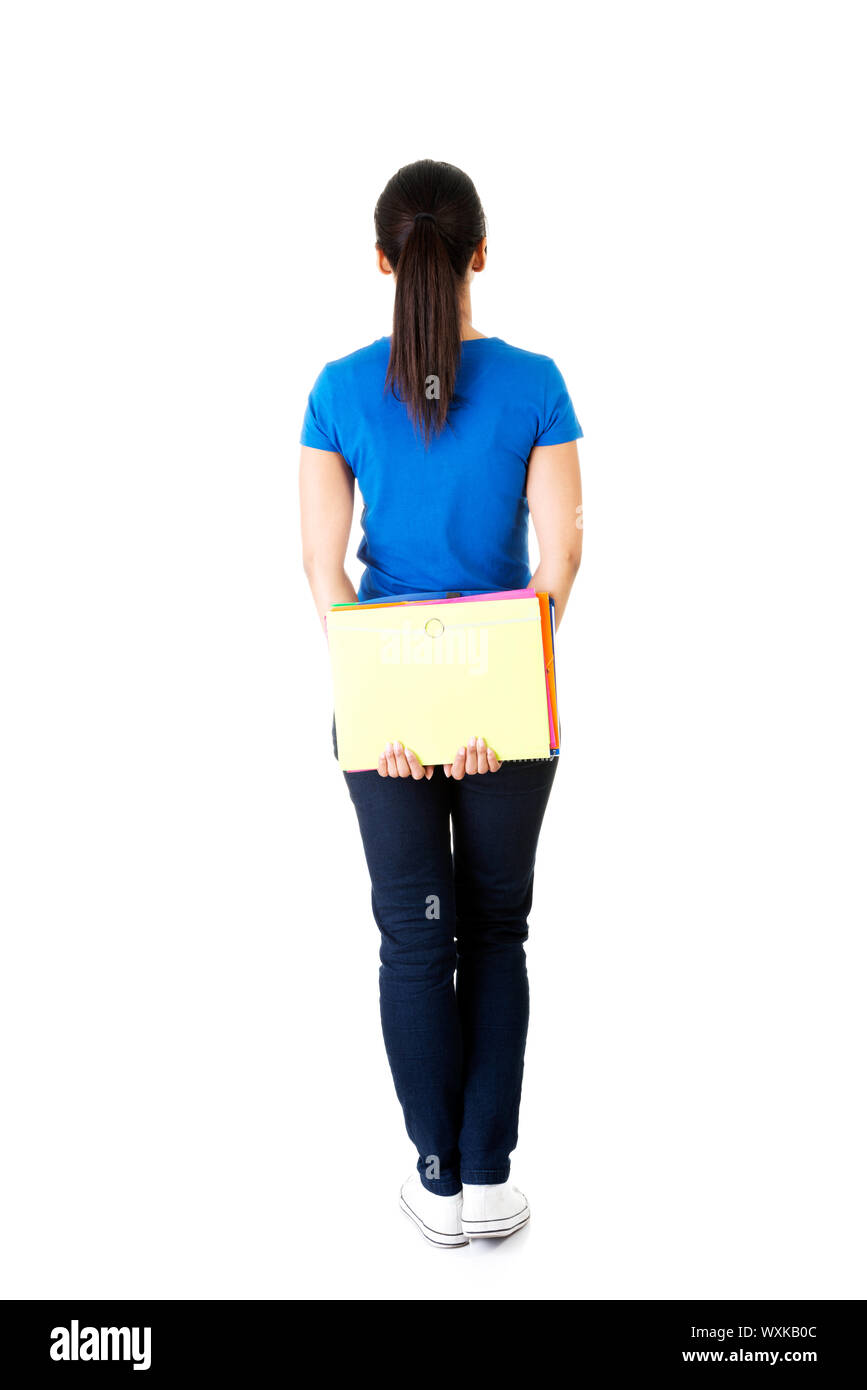 Back view of young student woman holding notebook.. Isolated over white ...
