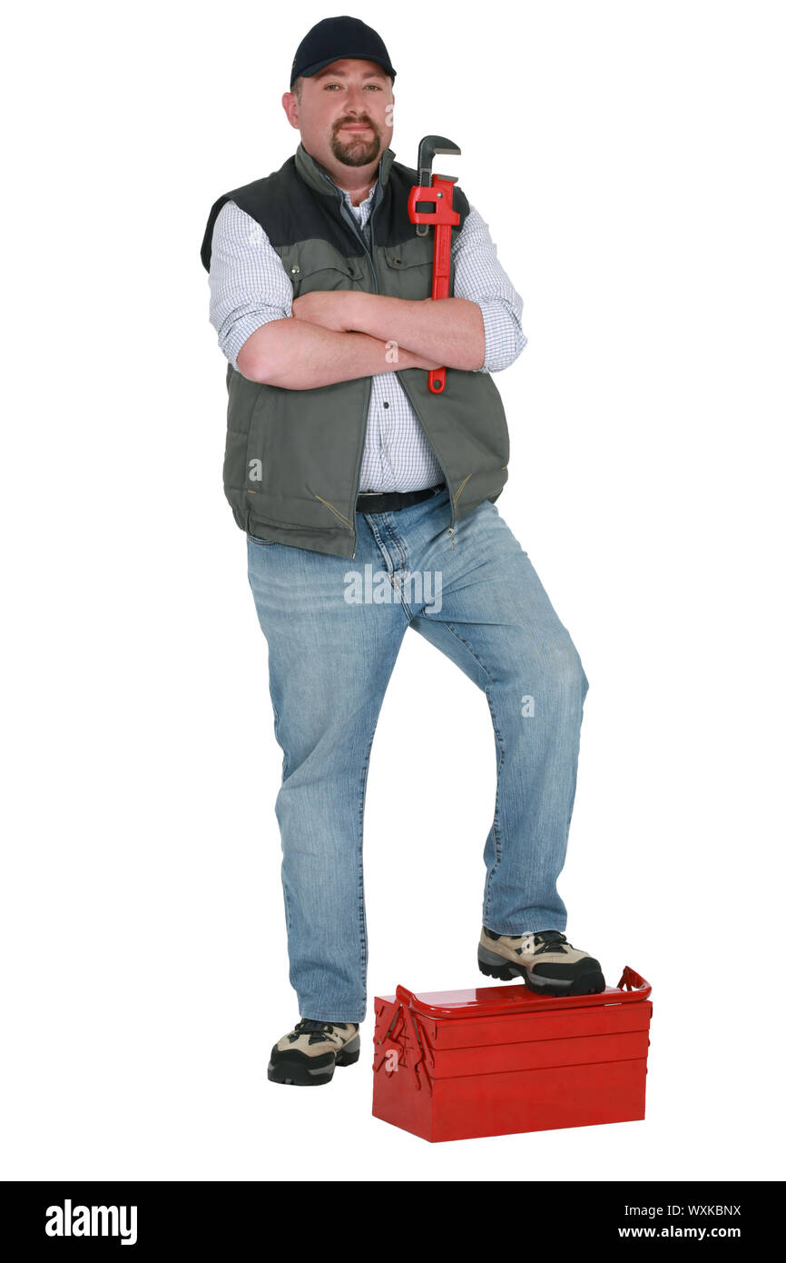 Worker resting foot on tool-box Stock Photo - Alamy