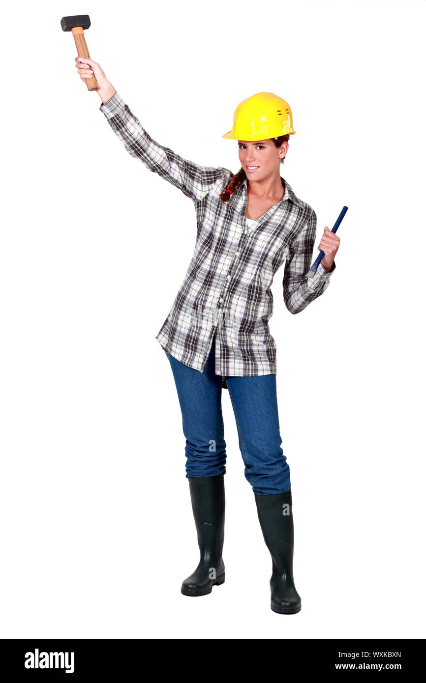 A female construction worker with a hammer Stock Photo - Alamy
