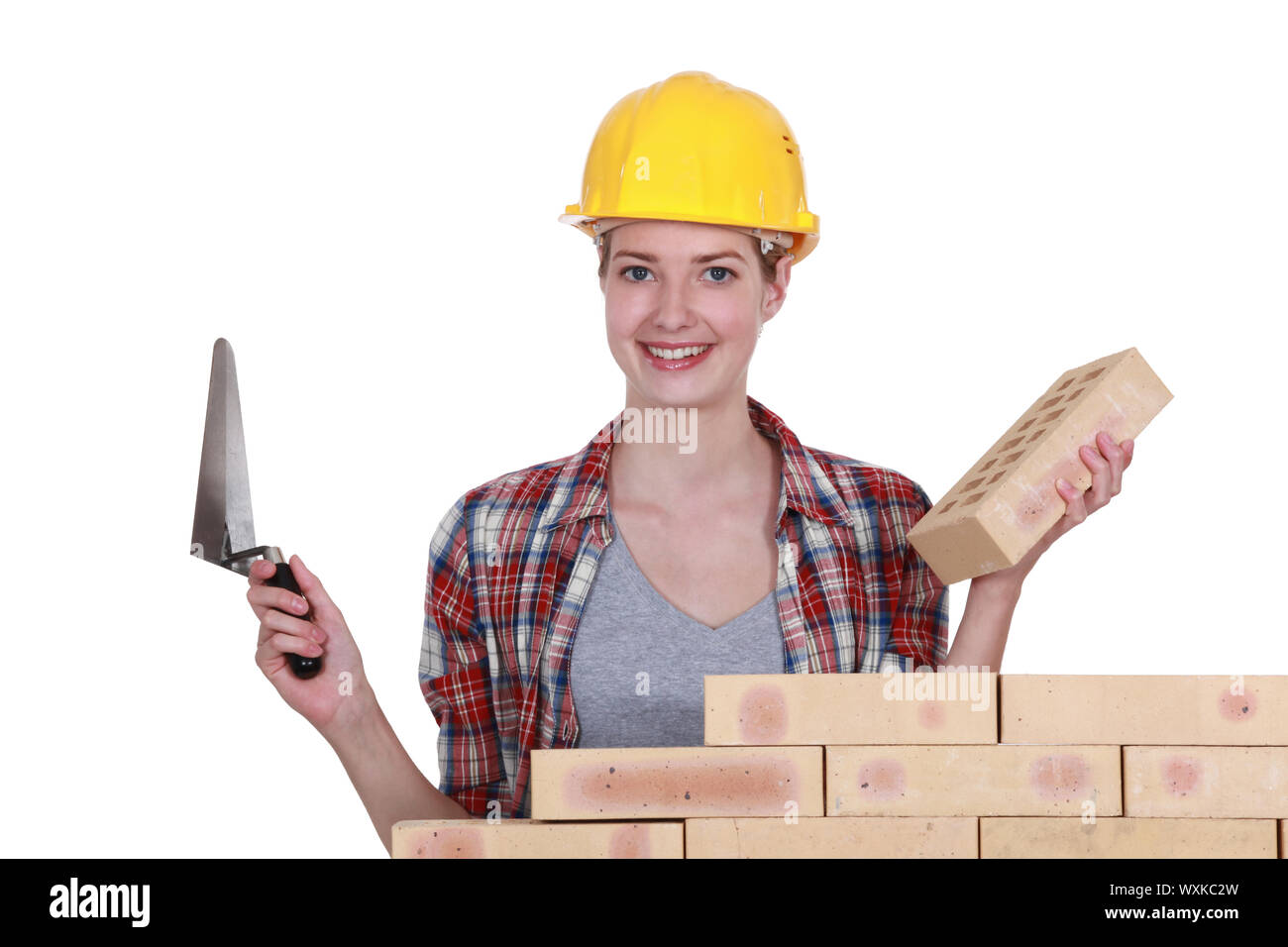 Female mason stood by wall Stock Photo - Alamy