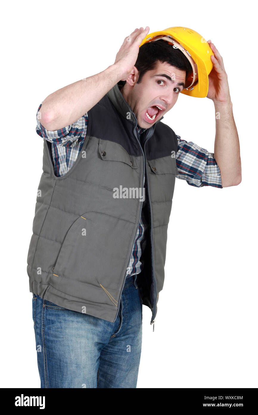 Shocked construction worker Stock Photo - Alamy