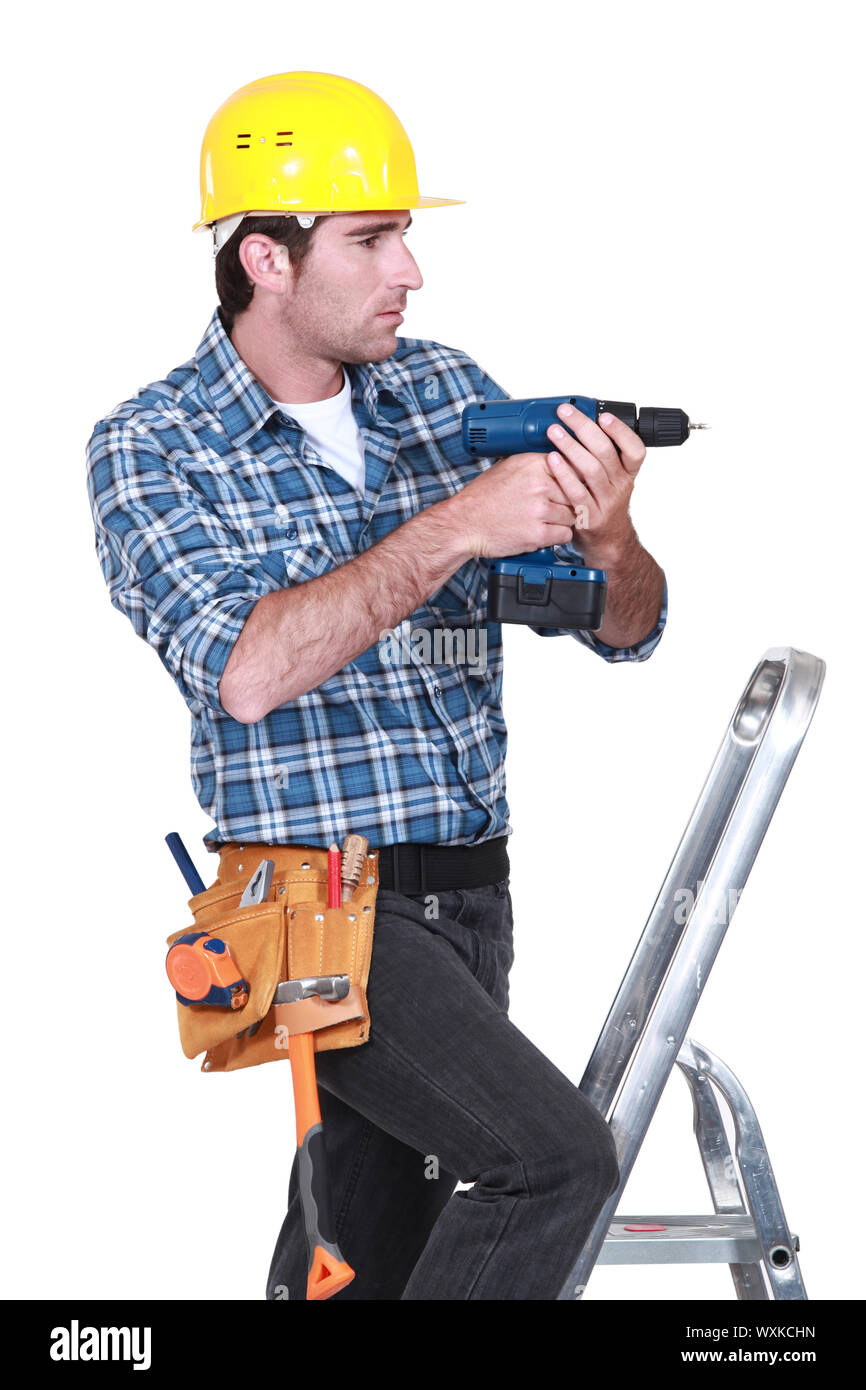 Tradesman using an electric screwdriver Stock Photo - Alamy
