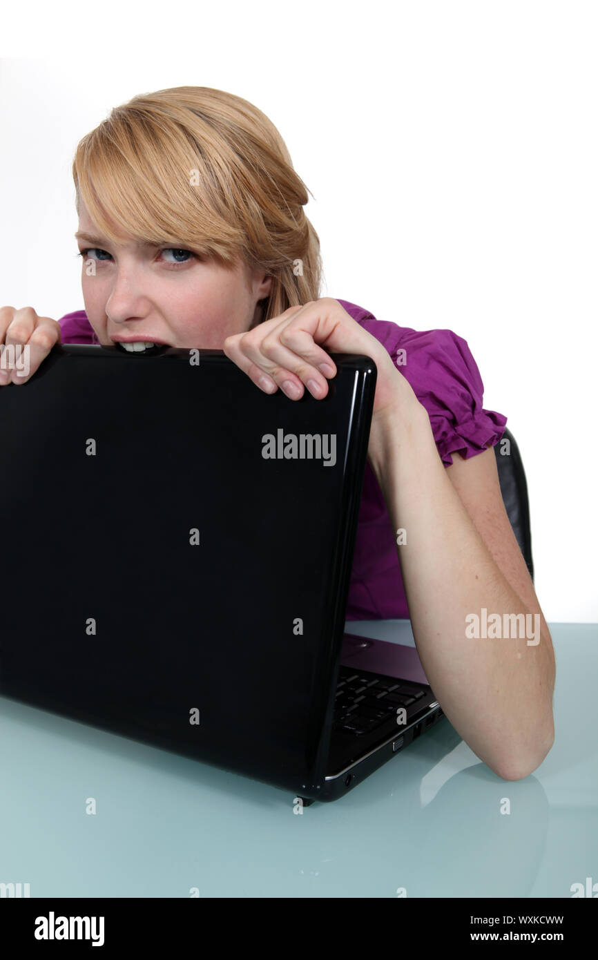 Frustrated woman biting her laptop hi-res stock photography and images ...