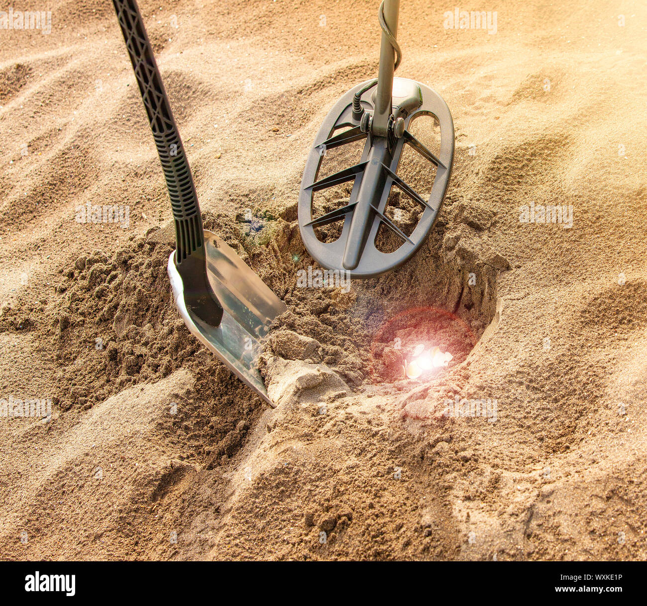 The metal detector and shiny treasures Stock Photo - Alamy
