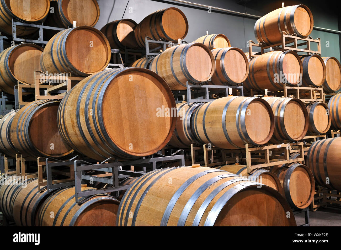 Stacked oak wine barrels in winery cellar Stock Photo - Alamy