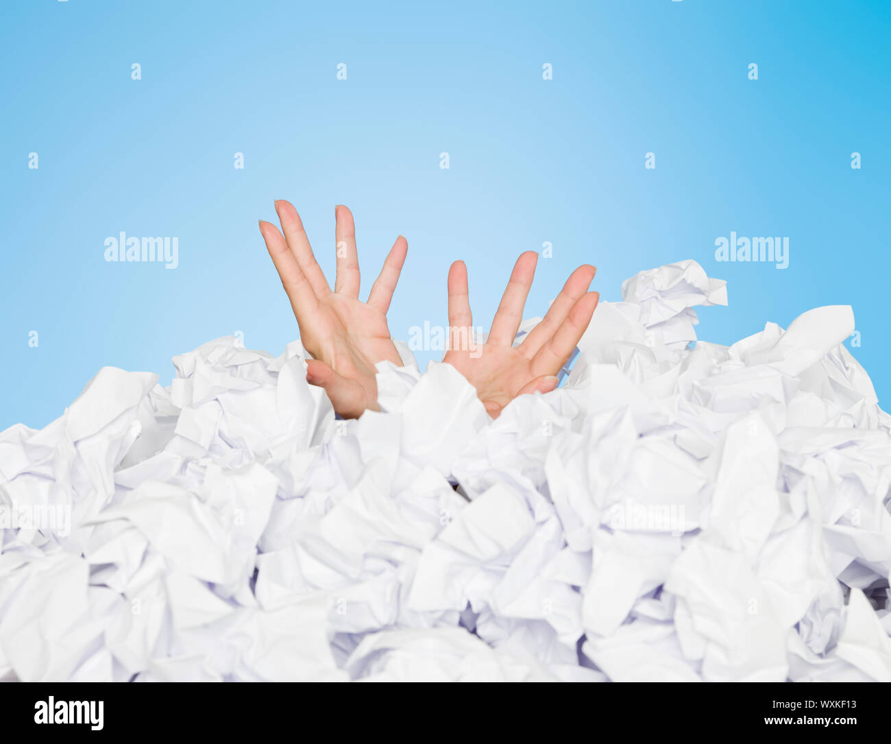 Human buried in white papers on blue background Stock Photo - Alamy