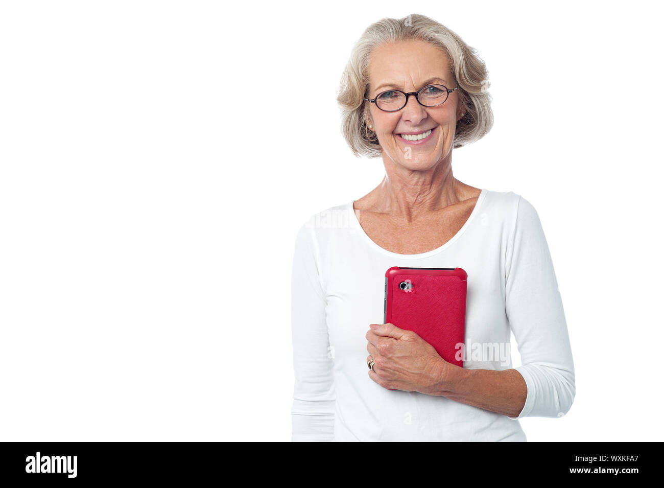 Pretty aged lady holding red color tablet device Stock Photo - Alamy