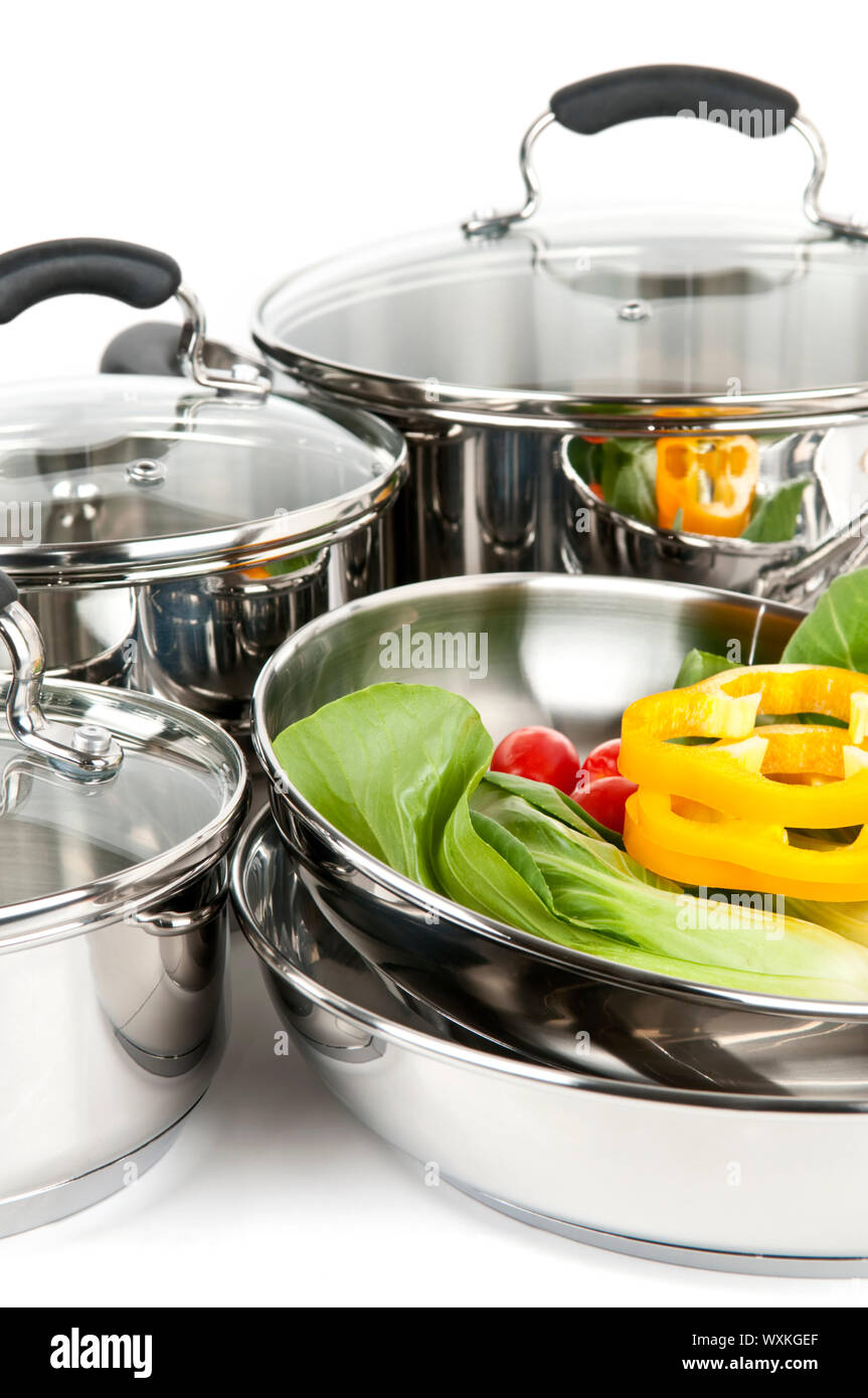 Stainless steel pots and pans isolated on white background with ...