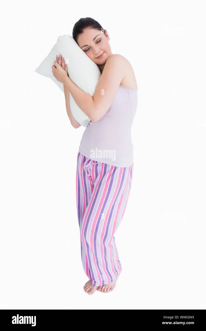 Standing woman sleeping on a pillow on a white background Stock Photo ...