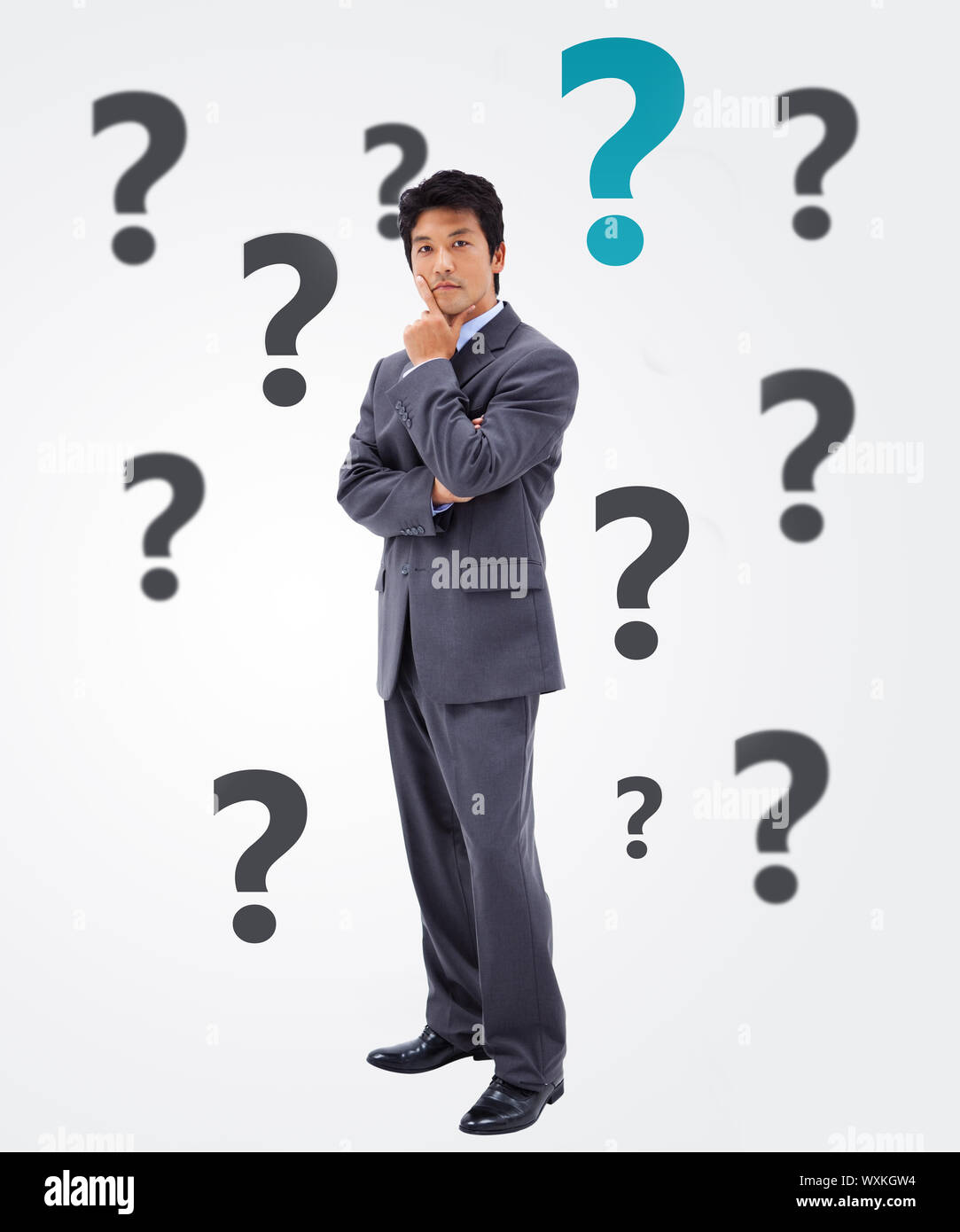 Questioning businessman on white background with question marks Stock ...