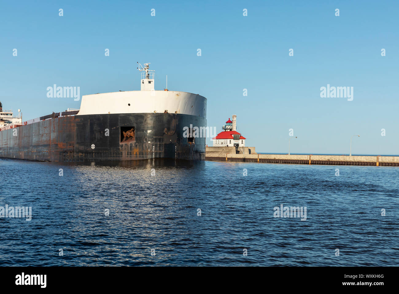 A Ship Passing A Lighthouse Stock Photo - Alamy