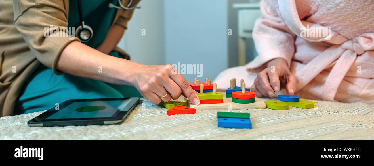Female doctor showing geometric shapes to elderly patient Stock Photo ...