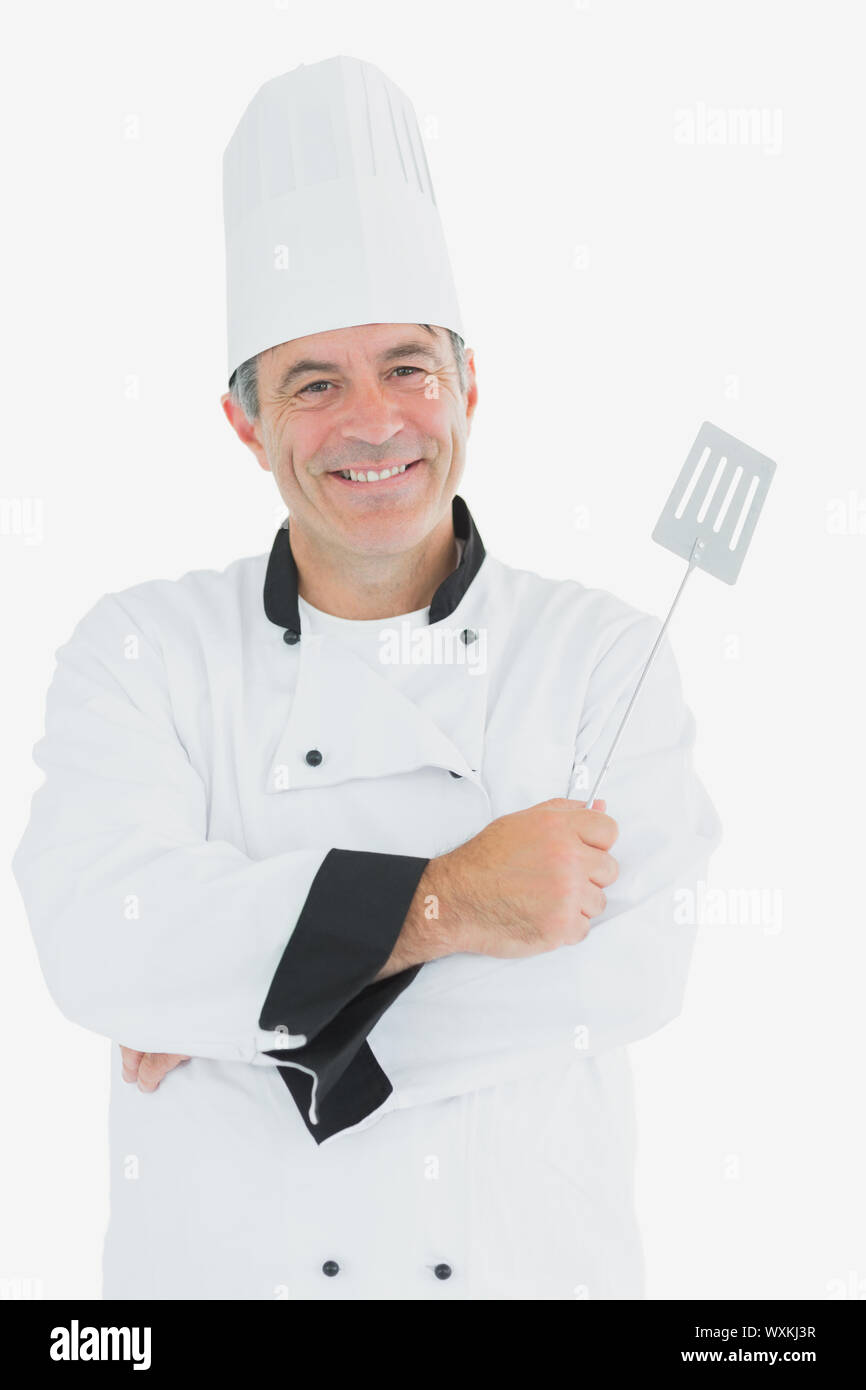 Portrait Of Happy Male Chef Holding Spatula Over White Background Stock portrait-of-happy-male-chef-holding-spatula-over-white-background-stock