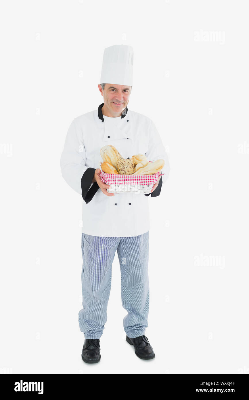 Full length portrait of happy male chef holding basket filled with ...
