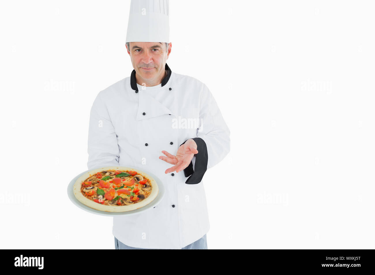 Portrait of confident chef displaying pizza over white background Stock ...