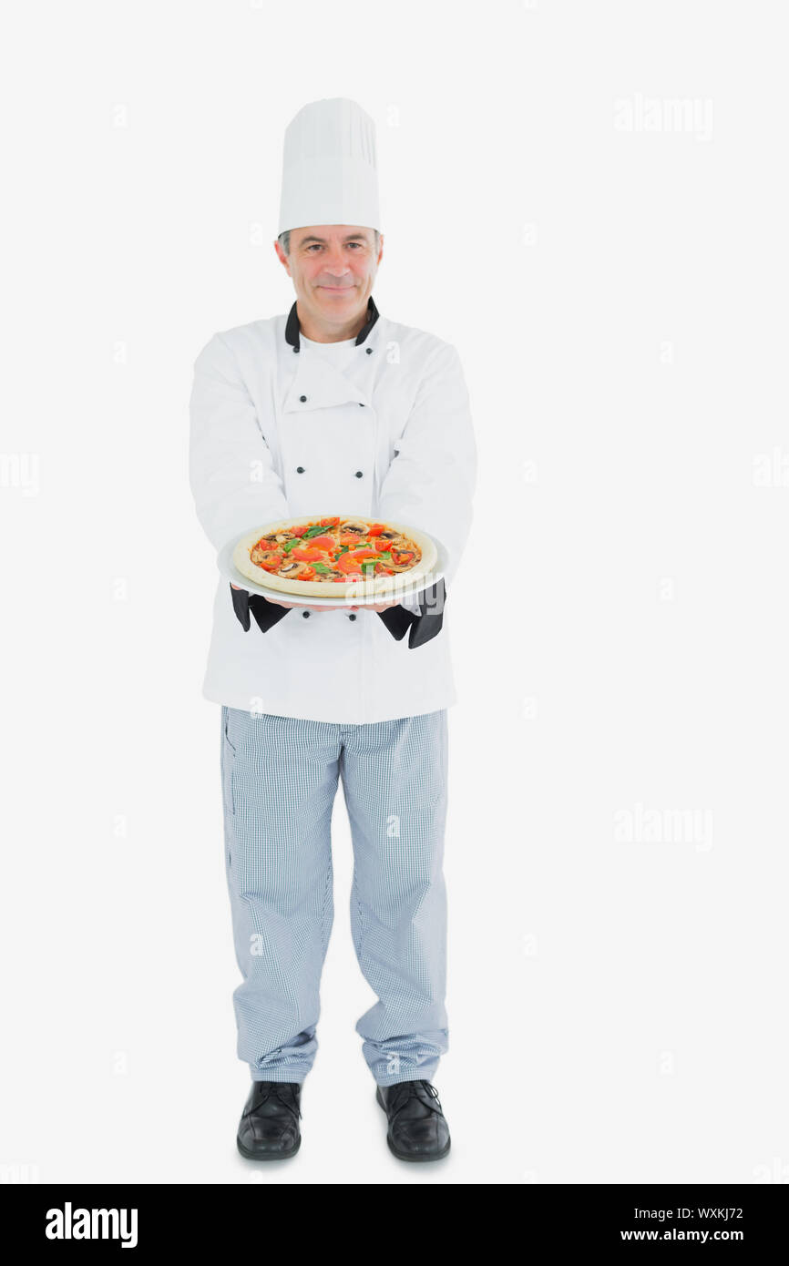 Full length portrait of male chef holding pizza over white background ...