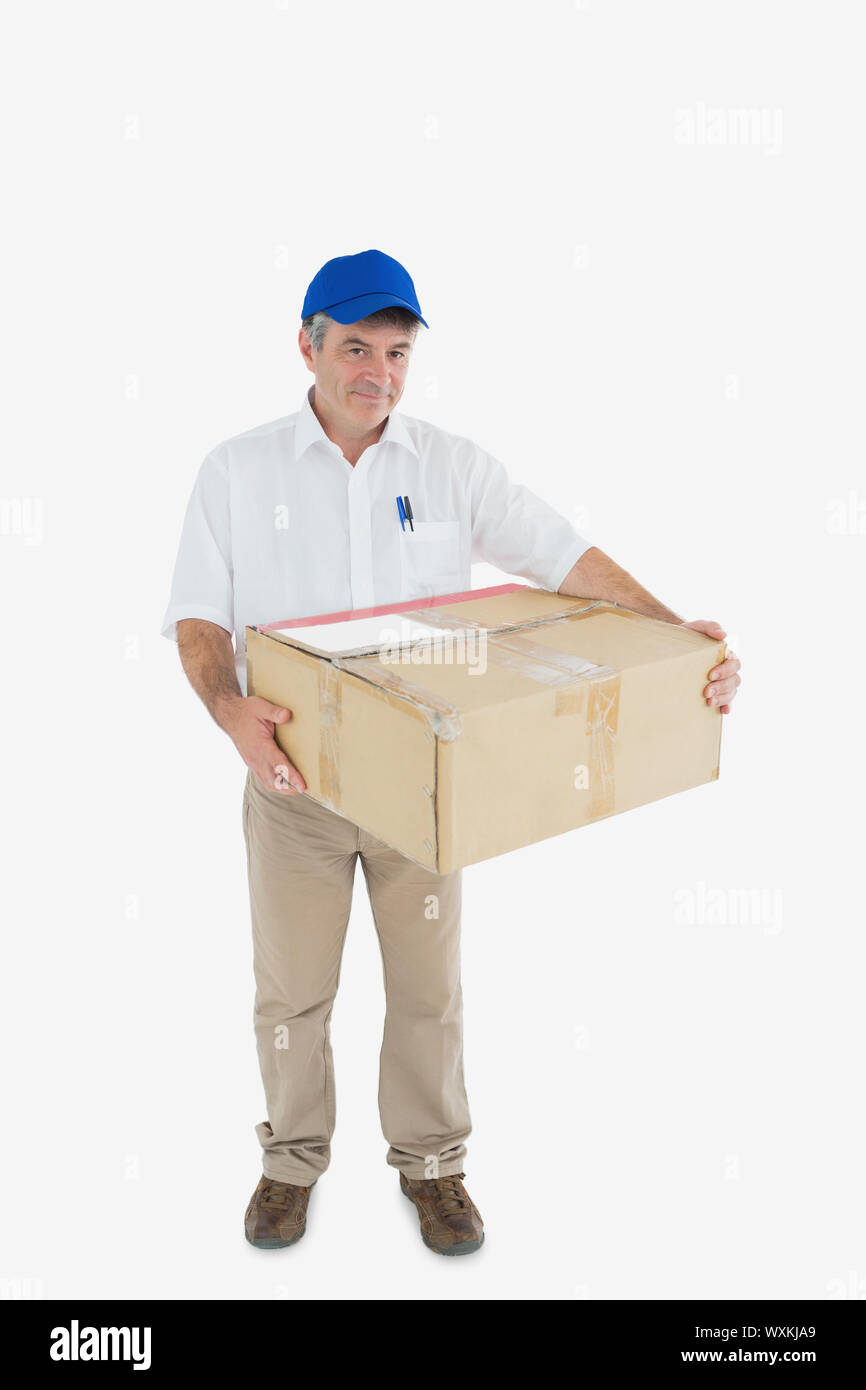 Portrait of courier man carrying cardboard box against white background ...