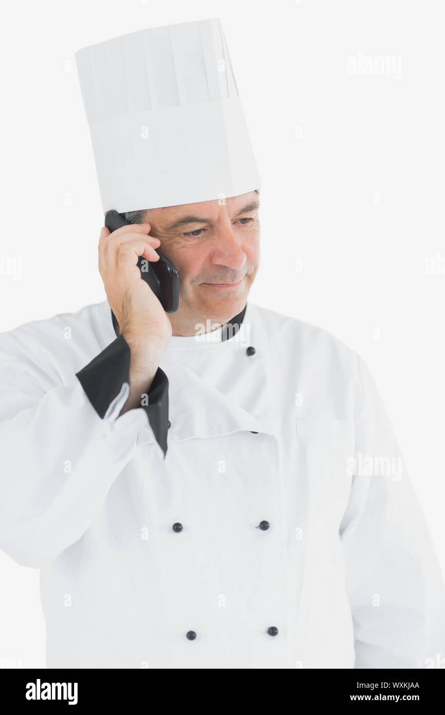Male chef using cell phone against white background Stock Photo - Alamy