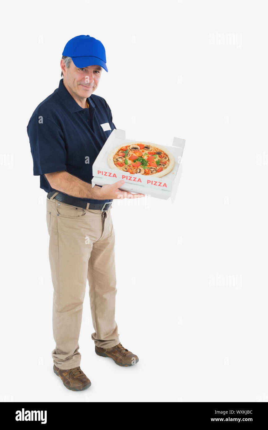 Portrait of mature pizza delivery man standing against white background ...