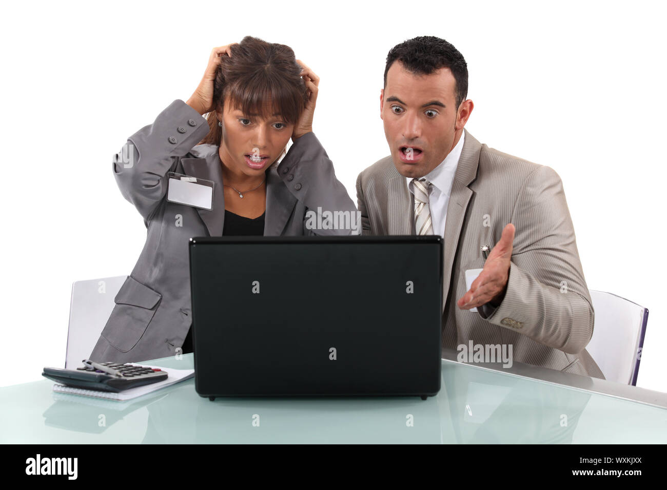 Two business people shocked by laptop Stock Photo - Alamy