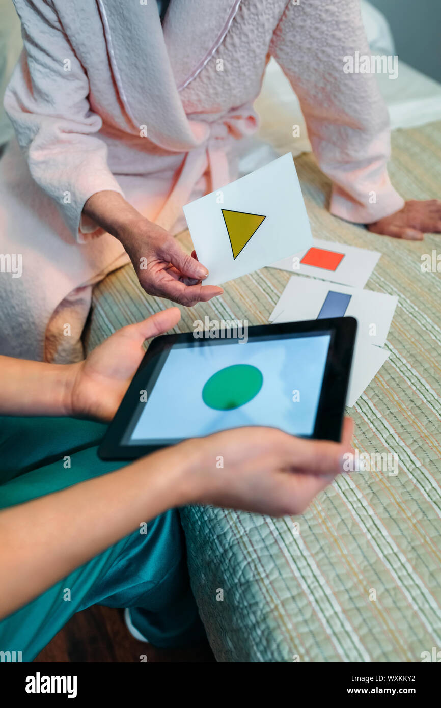 Female doctor showing geometric shapes to elderly patient Stock Photo ...
