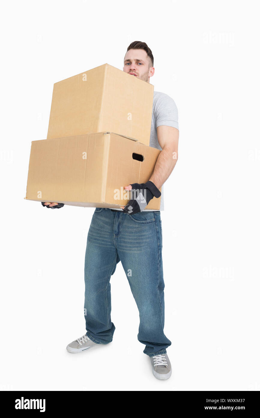 Portrait of young man carrying package boxes over white background ...